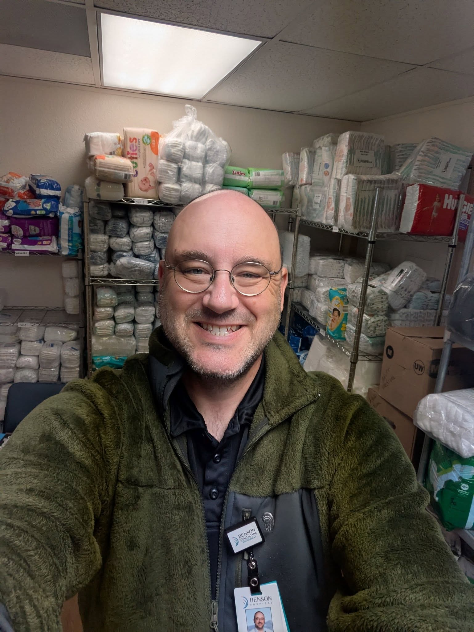 Jacob at Benson Hospital in front of diaper storage